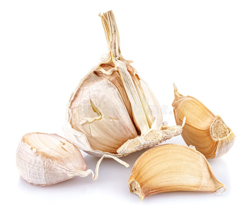 Three Garlic Cloves in the Peel Against Whole Garlic Head Isolated on ...