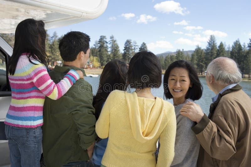 Three-generation Family Looking at Lake Back View Stock Image - Image ...