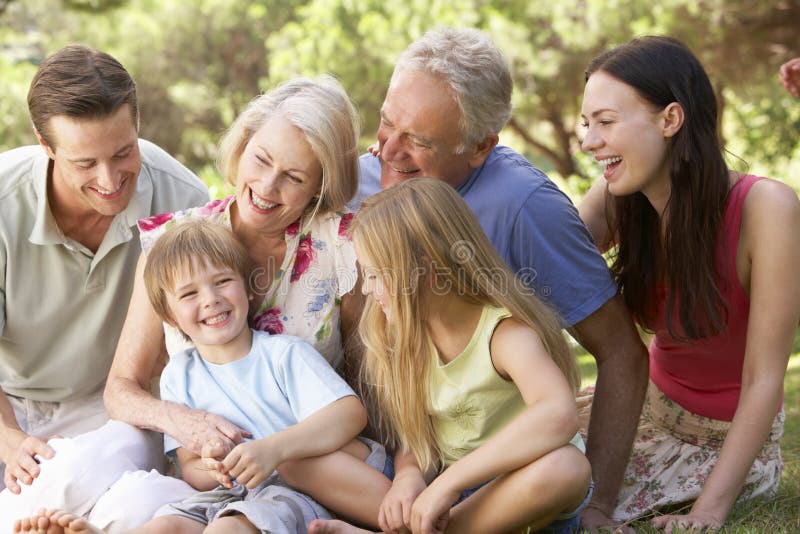 Three Generation Family Sitting in Park Together Stock Image - Image of ...