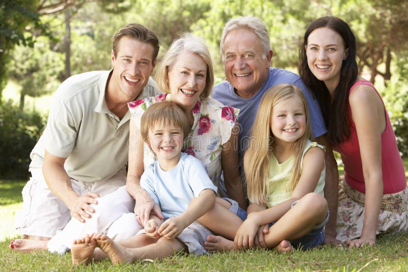 Three Generation Family Sitting in Park Together Stock Image - Image of ...