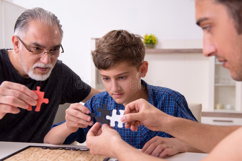 Three Generations of Family Playing Jigsaw Puzzle Game Stock Photo ...