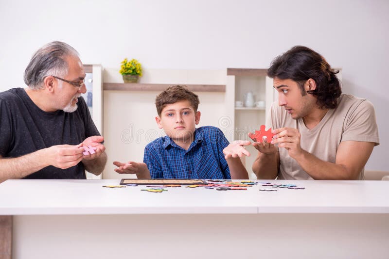 Three Generations of Family Playing Jigsaw Puzzle Game Stock Photo ...