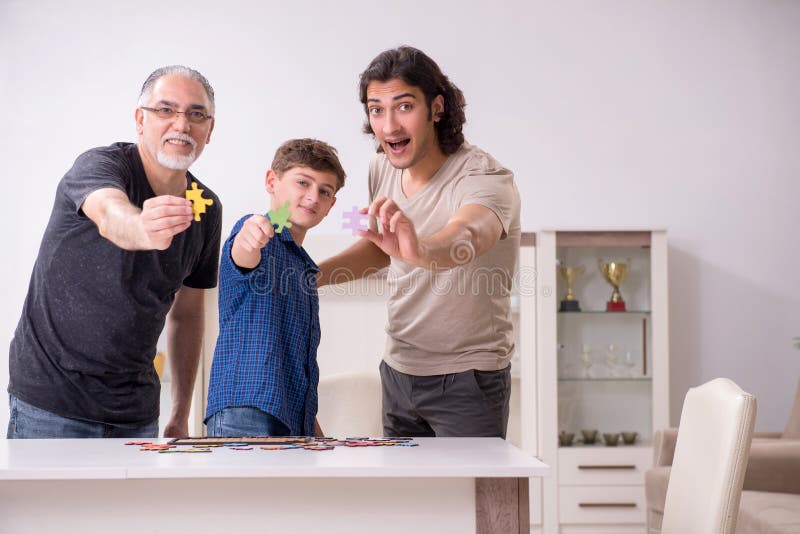 Three Generations of Family Playing Jigsaw Puzzle Game Stock Photo ...