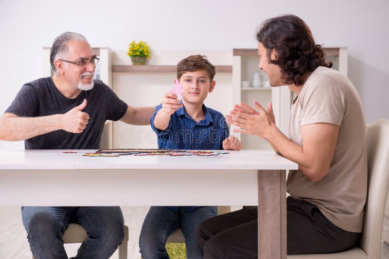 Three Generations of Family Playing Jigsaw Puzzle Game Stock Image ...