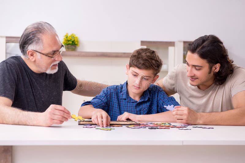 Three Generations of Family Playing Jigsaw Puzzle Game Stock Photo ...