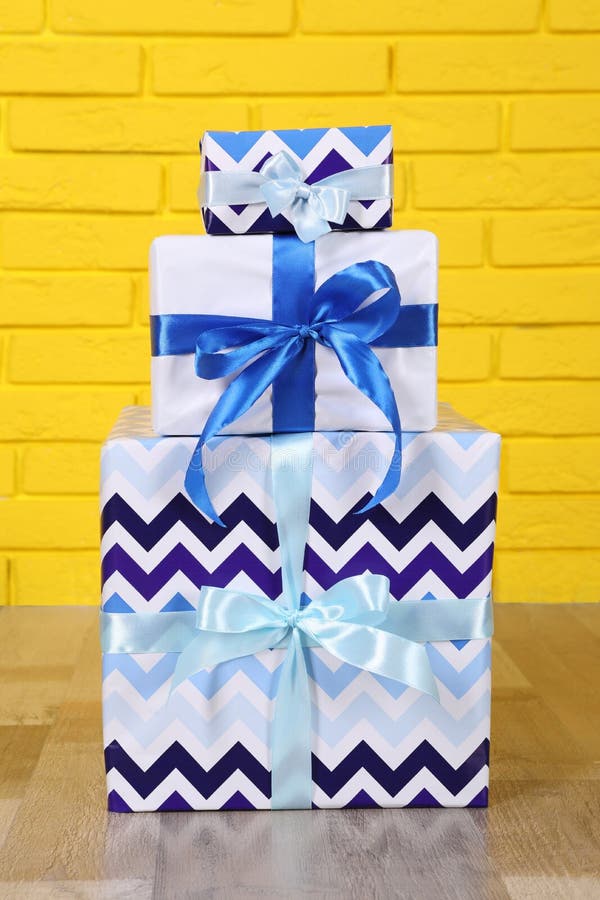 Three Gift Boxes Near Yellow Brick Wall Stock Photo - Image of closeup ...