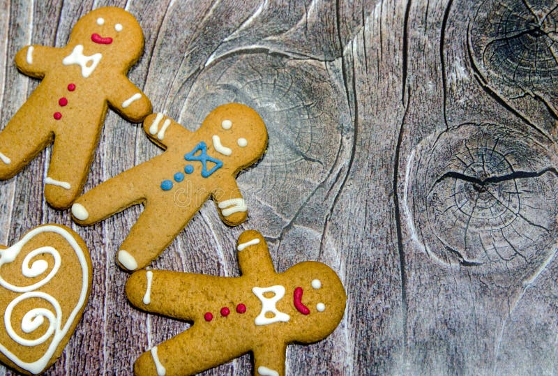 Three Gingerbread Men on Wood Stock Photo - Image of childhood, cookie ...