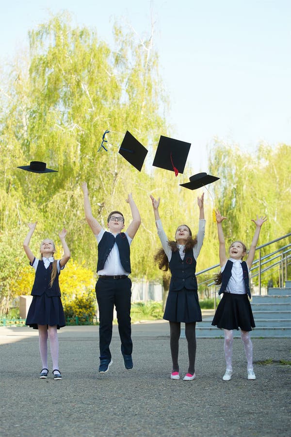 Three Girls and a Boy are Elementary School Graduates in a Graduate Hat ...