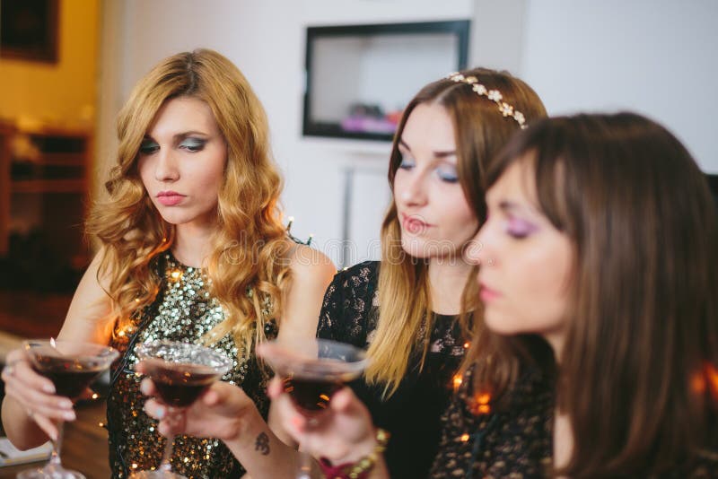 Three Girls Checking Their Drinks at a Party Stock Image - Image of ...