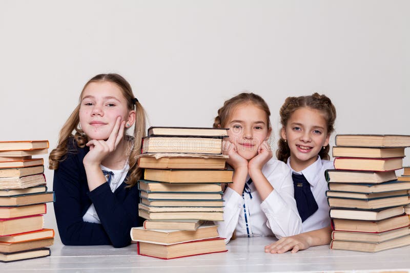 Three Girls in the Classroom Studying Many Books Stock Photo - Image of ...