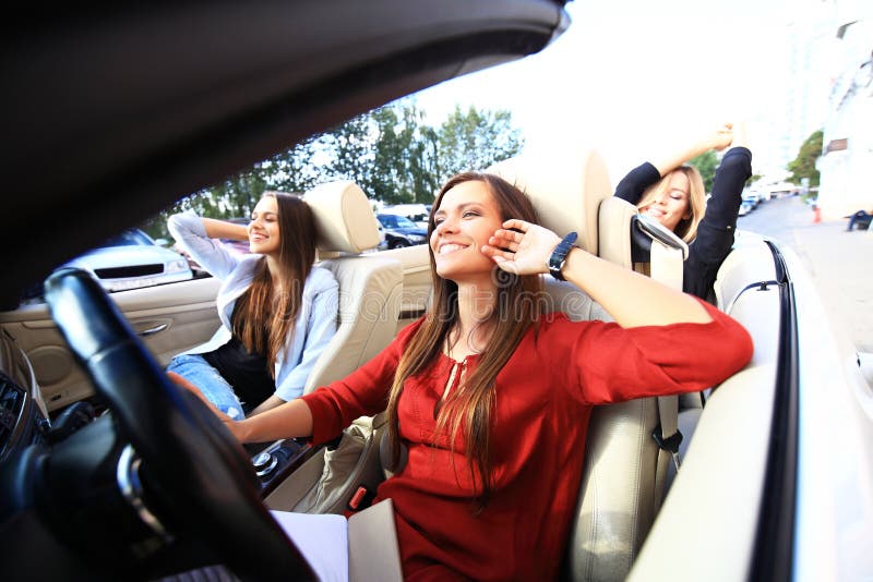 Three Girls Driving in a Convertible Car and Having Fun. Stock Photo ...