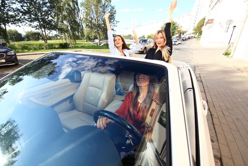 Three Girls Driving in a Convertible Car and Having Fun. Stock Photo ...