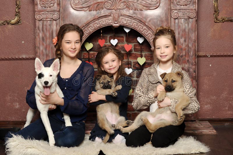 Three girls with puppies stock photo. Image of canine - 31694068