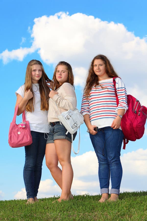 Three Girls Stand with Bags on Grass Stock Image - Image of friendship ...