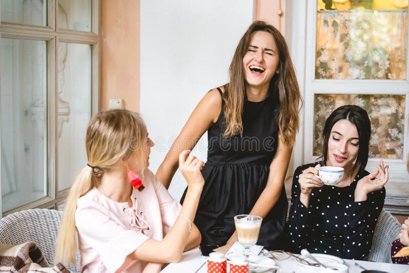 Three girls at the table stock image. Image of beautiful - 127542721