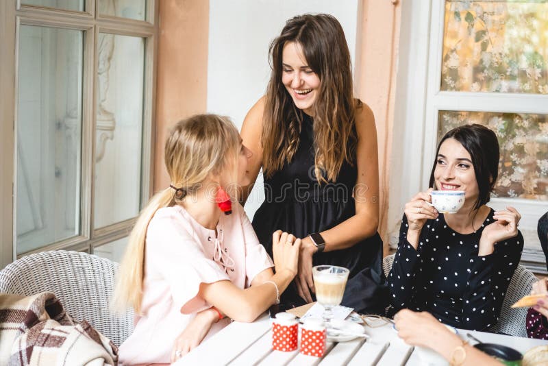 Three girls at the table stock image. Image of friends - 128771013