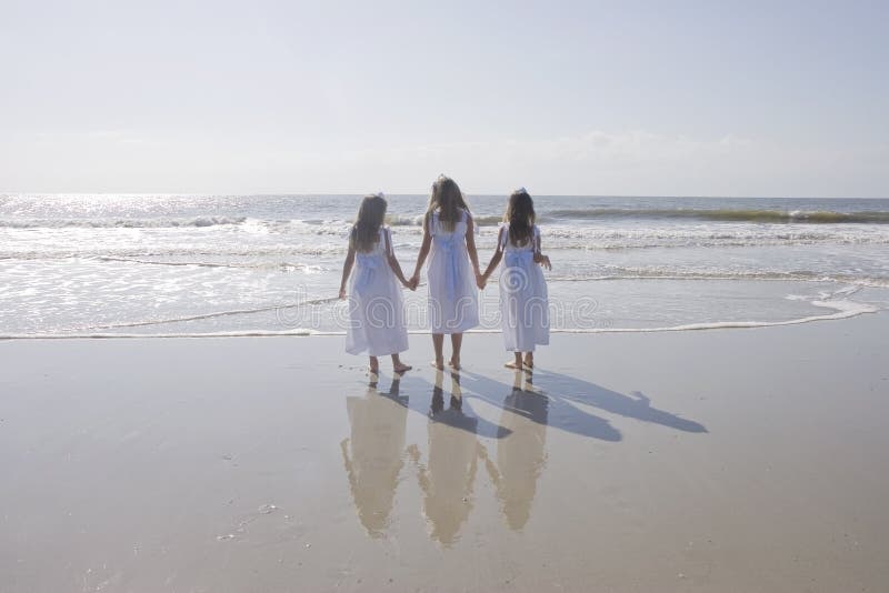 Three Sisters Holding Hands Stock Photo - Image of ocean, barefoot: 2504288