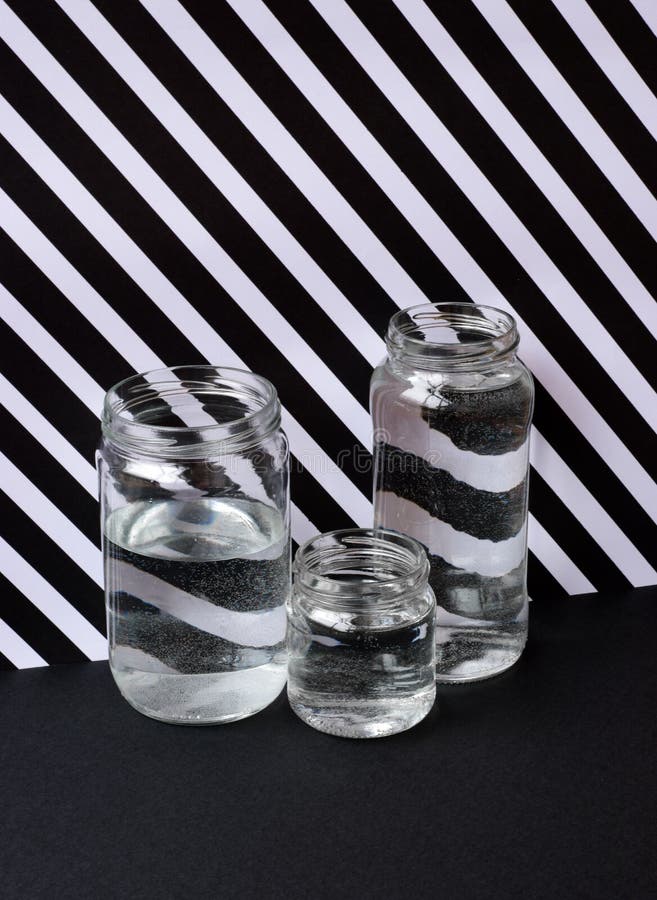 Three Glass Jars of Different Sizes Filled with Water on a Background ...
