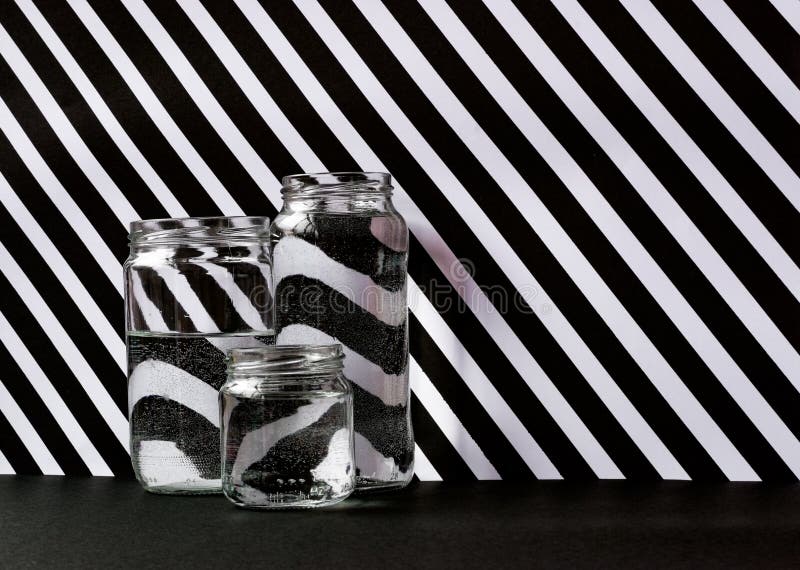 Three Glass Jars Placed Together of Different Sizes with Water ...