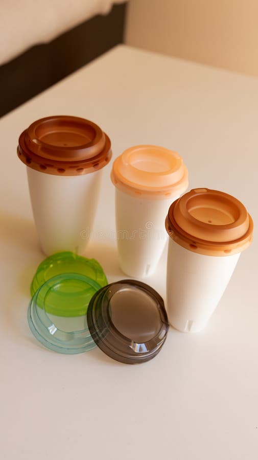 Three Glasses of Coffee on the Table with Different Colored Lids Stock ...