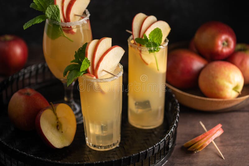 Three Glasses of Refreshing Apple Cocktail Drinks with Fresh Red Apples ...