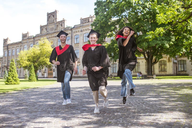 Three Graduates Running in the Park and Having Fun Stock Photo - Image ...