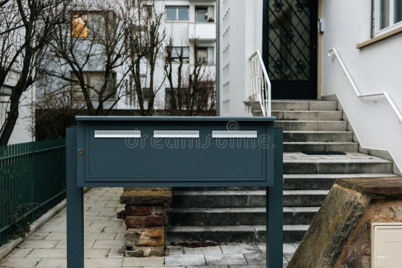 Three Gray Mailboxes in Front of Modern House Stock Photo - Image of ...