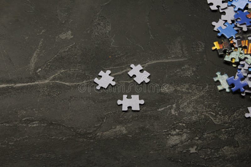 Three Gray Puzzle Pieces on a Black Surface Stock Image - Image of ...