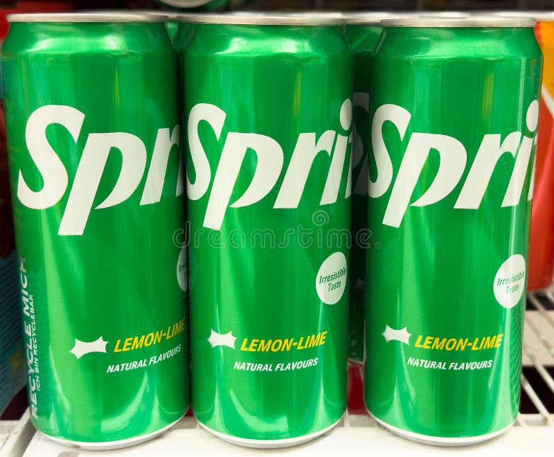 Three Green Cans of Lemon-lime Drink on Refrigerated Shelf Editorial ...