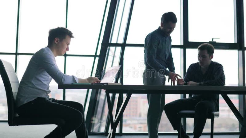 Three Guys Working Together on a Team Project, All with Their Laptops ...