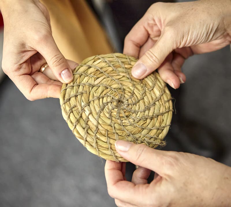 Three Hands Hold a Round Grass Mat Stock Image - Image of labor, people ...