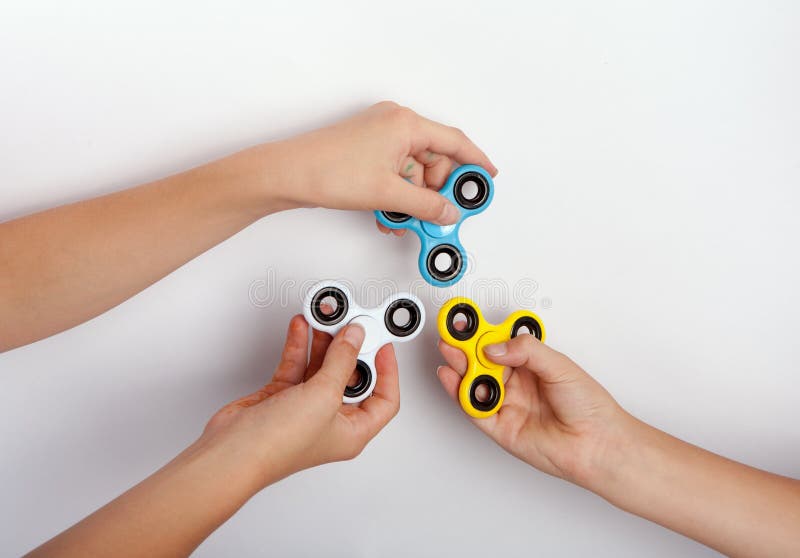 Three Hands Showing Fidget Spinners in Different Colors Stock Image ...