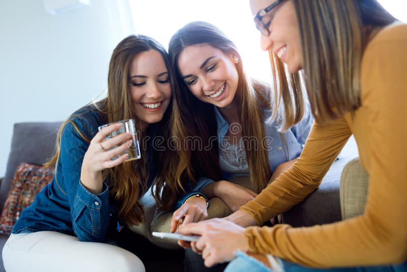 Three Happy Beautiful Women Using Smartphone at Home. Stock Image ... Three Happy Beautiful Women Using Smartphone at Home. Stock Image ...