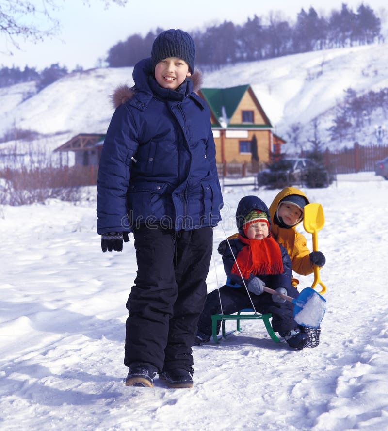 Three happy boys on sled stock photo. Image of brother - 47193086