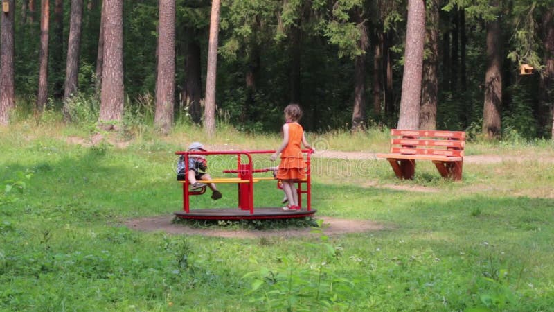 Three Happy Children Play on Roundabout in Green Park Stock Video ...