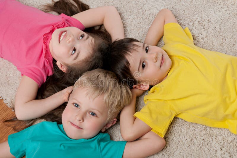 Three Happy Kids on the Grass Stock Image - Image of people, childhood ...