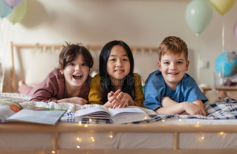Three Happy Friends Reading a Book Together in a Room. Stock Image ...