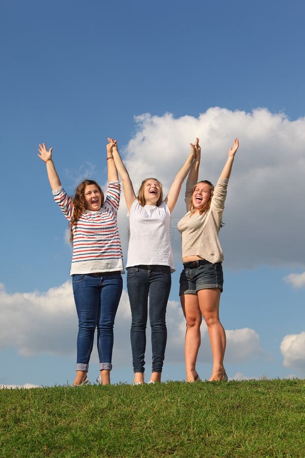 Three Happy Girls Pose At Grass Stock Image - Image: 27753963