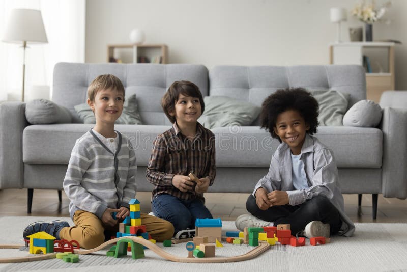 Three Happy Multiethnic Kids Playing Developing Game at Cozy Home Stock ...