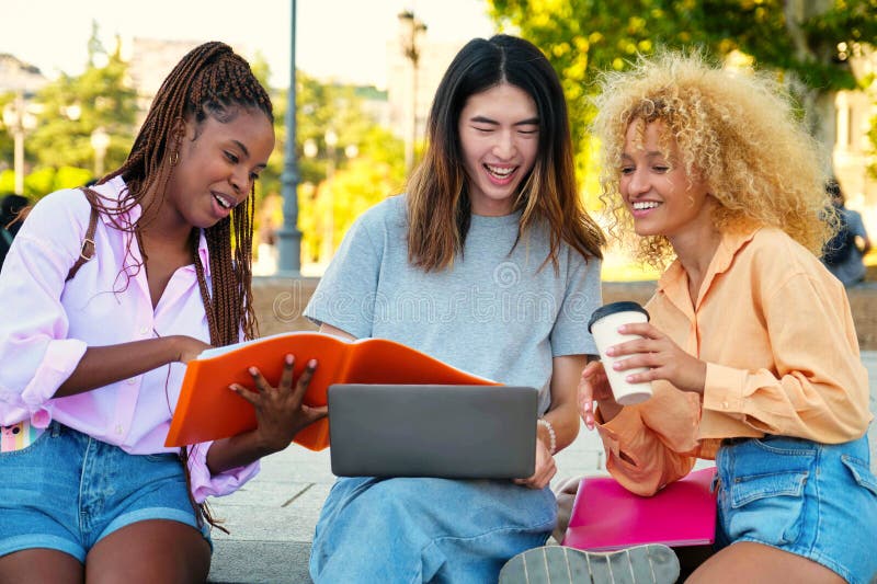 Three Happy Multiracial Friends Studying at a Park. Stock Image - Image ... Three Happy Multiracial Friends Studying at a Park. Stock Image - Image ...
