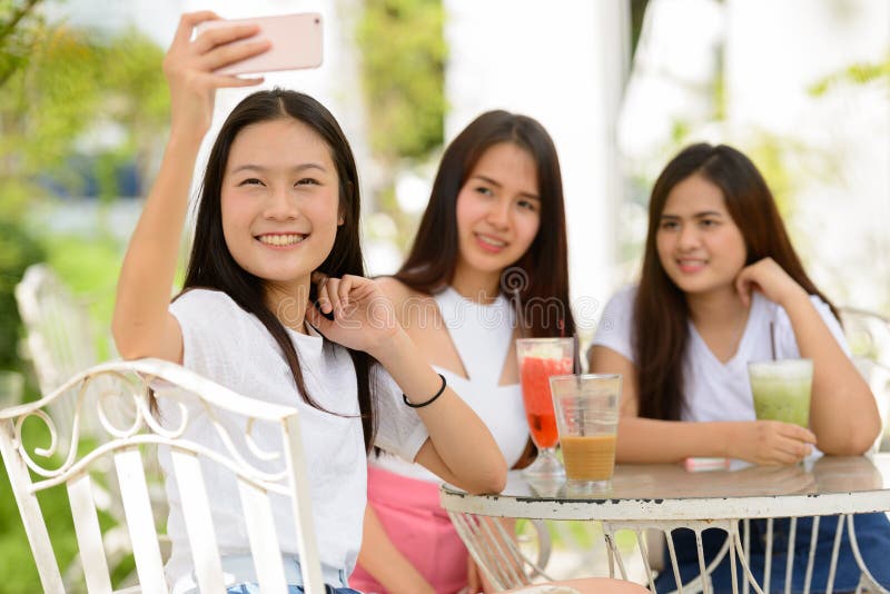 Three Happy Young Asian Women As Friends Taking Selfie Together At The