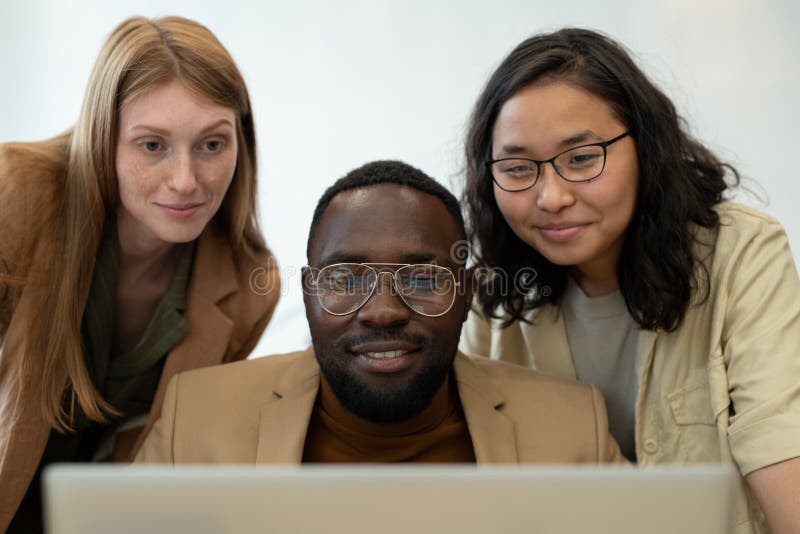 Three Happy Young Employees Looking at Screen of Laptop Stock Image ...