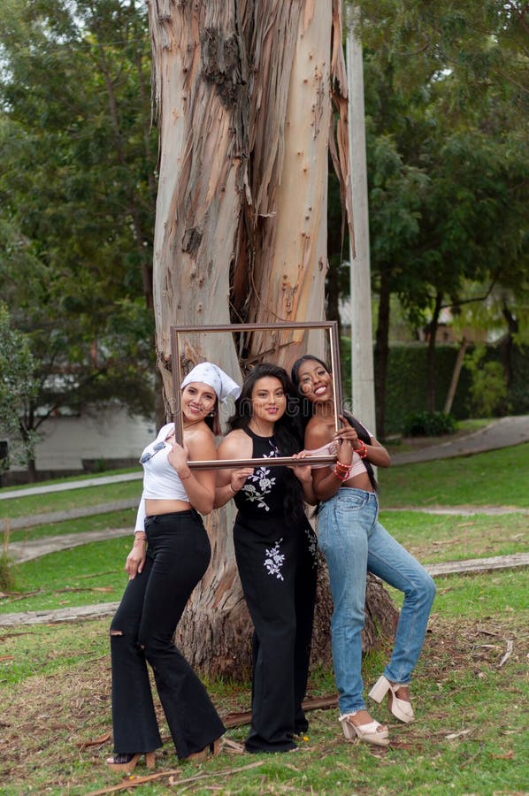 Three Happy Young Friends Posing with Photo Frame Stock Photo - Image ...