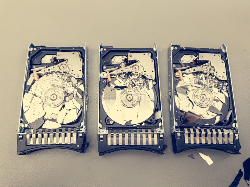 Three Hard Disk Drives with Shattered Platter on a Table. Stock Photo ...