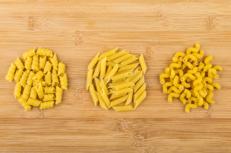 Three Heap of Different Pasta on Bamboo Table Stock Image - Image of ...