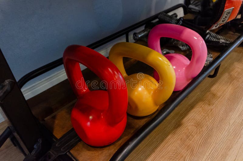 Three Large Kettle Bells Next To One Another in the Floor Stock Image ...