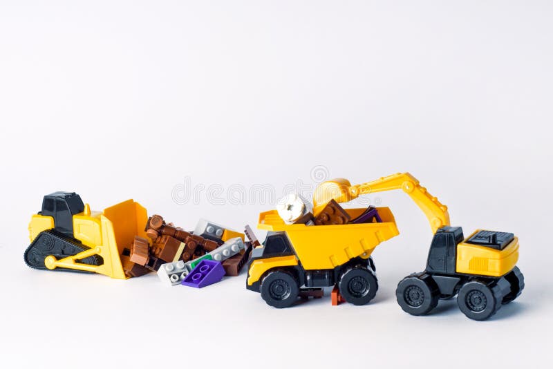Three Heavy Wheeled Front Loaders or Bulldozers on a White Isolated ...