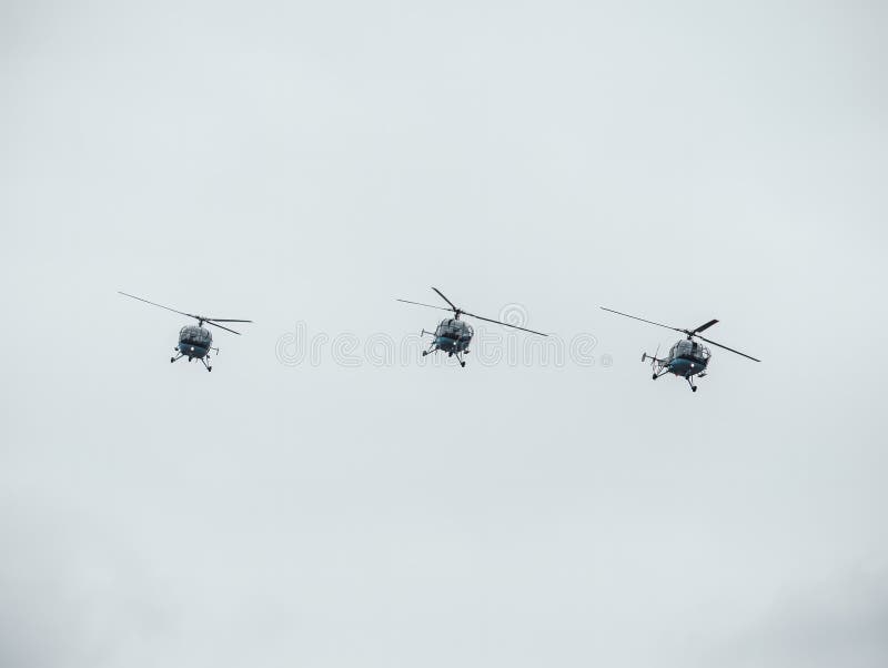 Three Helicopters Flying Against a Cloudy Sky. Airshow Demonstration ...