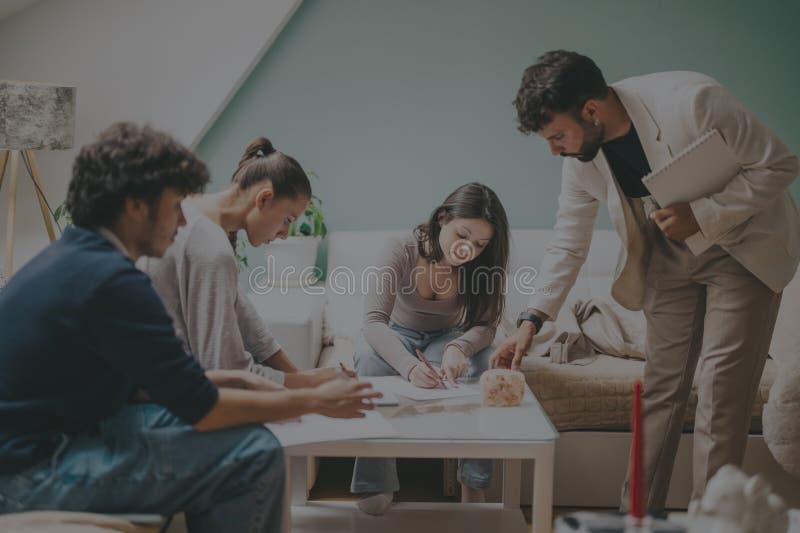 Three High School Students Work Together on a School Project with Their ...