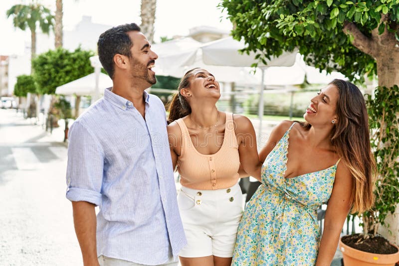 Three Hispanic Friends Smiling Happy and Hugging at the City Stock ...